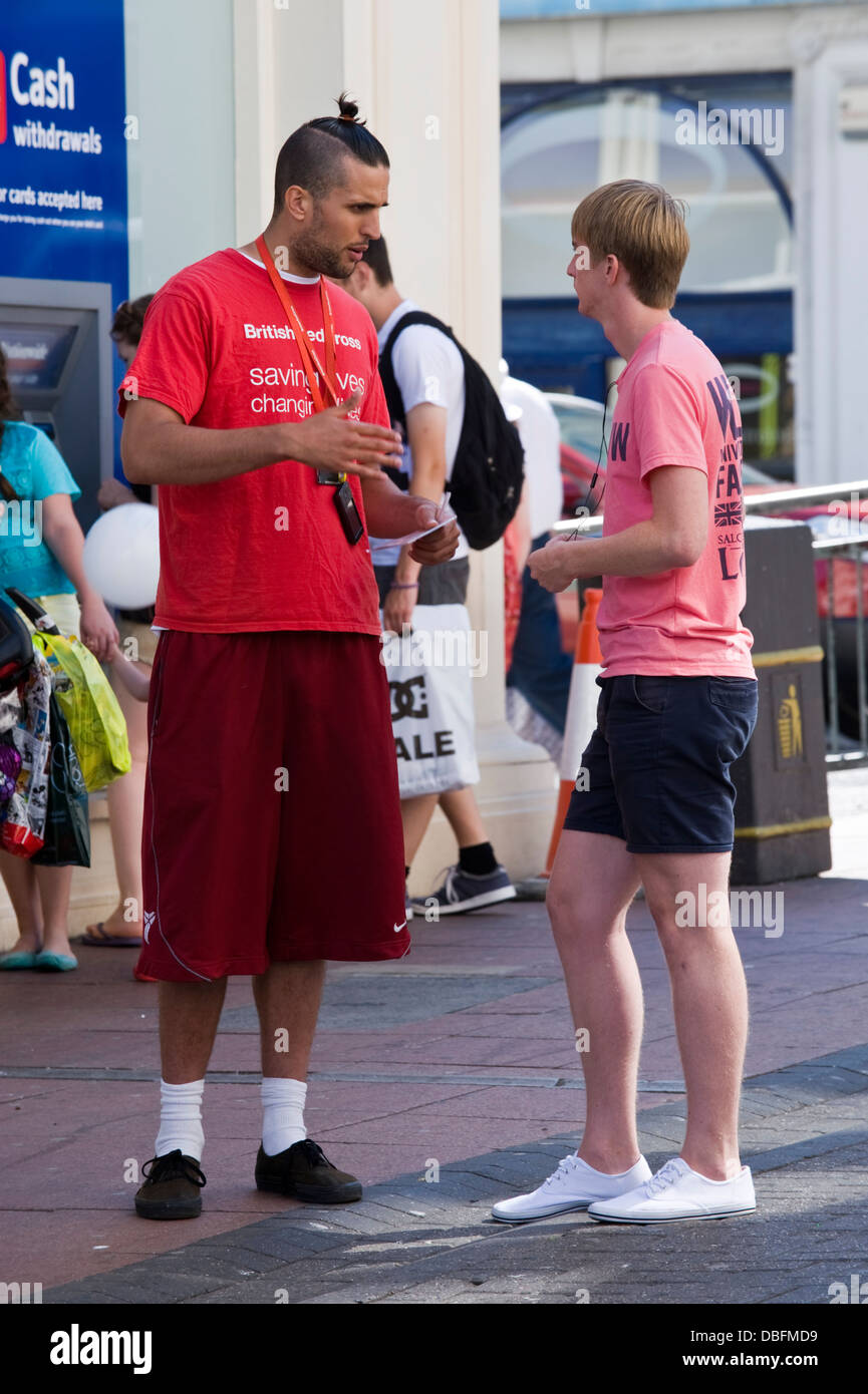 Charity fundraiser for British Red Cross raising money on the street in ...