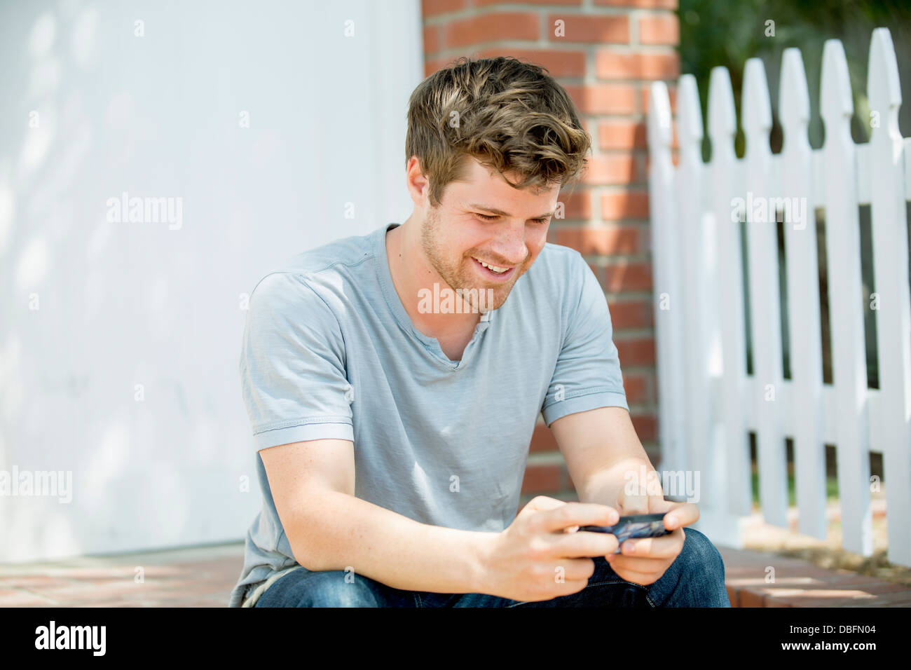 Man using cell phone outdoors Stock Photo - Alamy