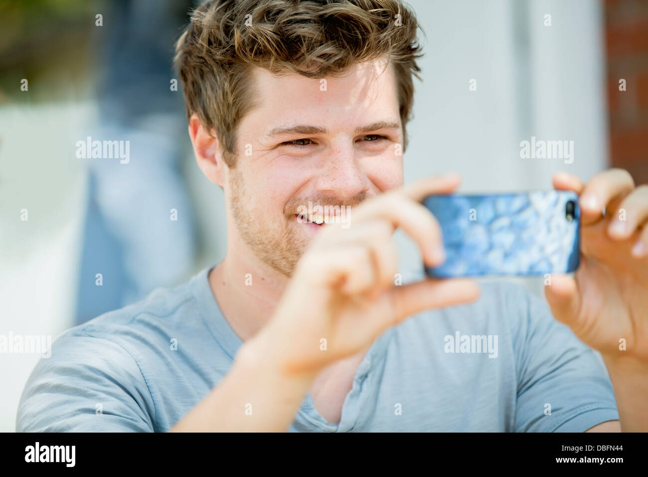 Man using cell phone outdoors Stock Photo - Alamy