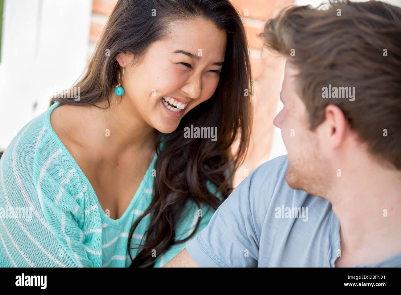 Couple laughing together outdoors Stock Photo - Alamy