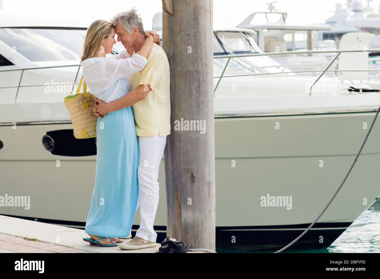 Caucasian couple hugging on dock Stock Photo - Alamy