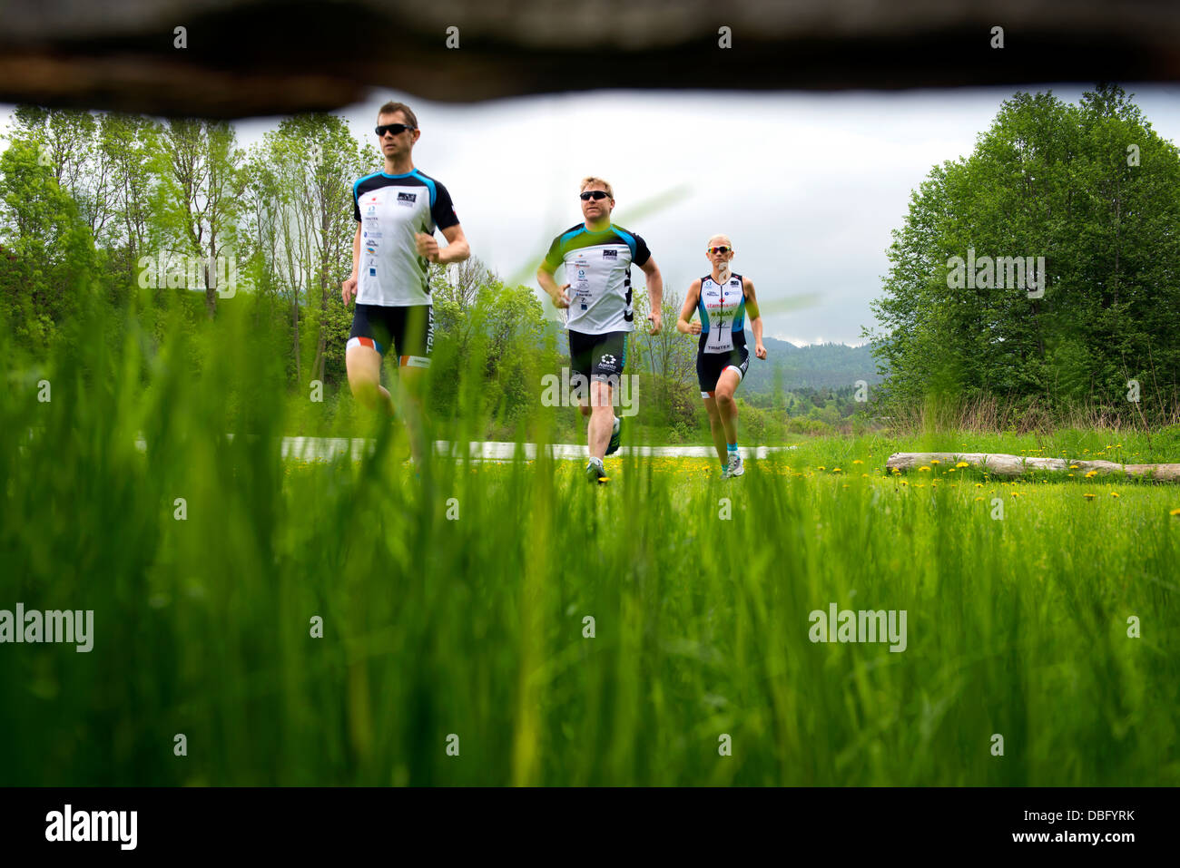 Three athletes running Stock Photo - Alamy