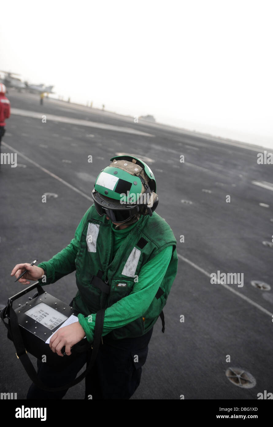 U.S. Navy Airman Kelsey Bell takes notes on the flight deck of the ...