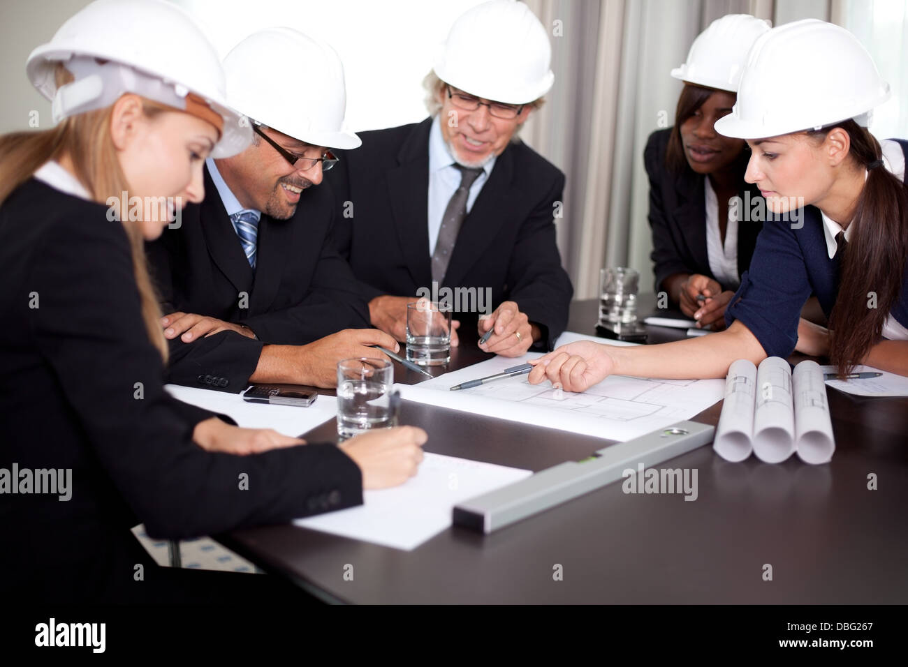 Happy successful engineers brainstorming Stock Photo - Alamy