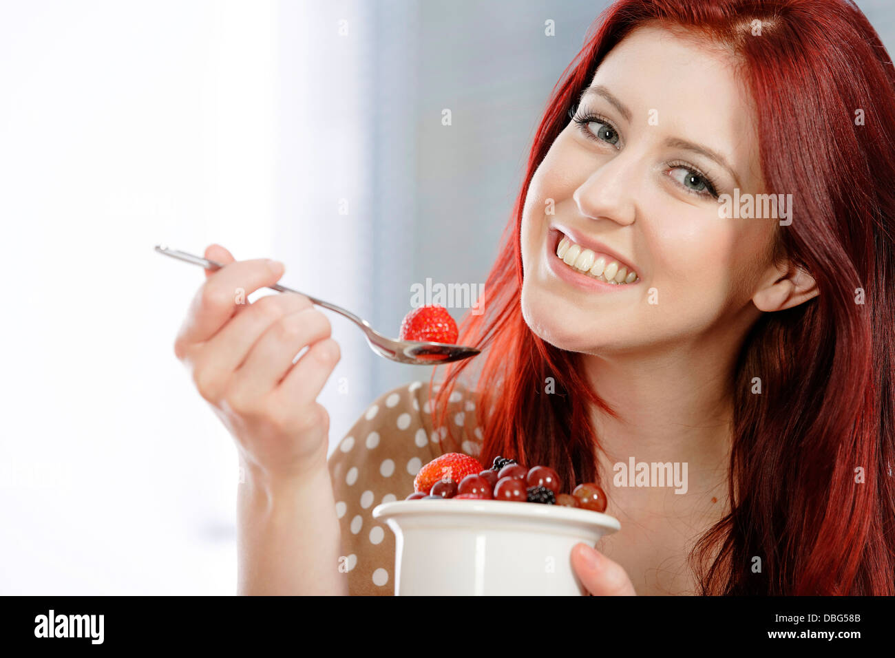 Happy woman enjoying fresh fruit Stock Photo - Alamy