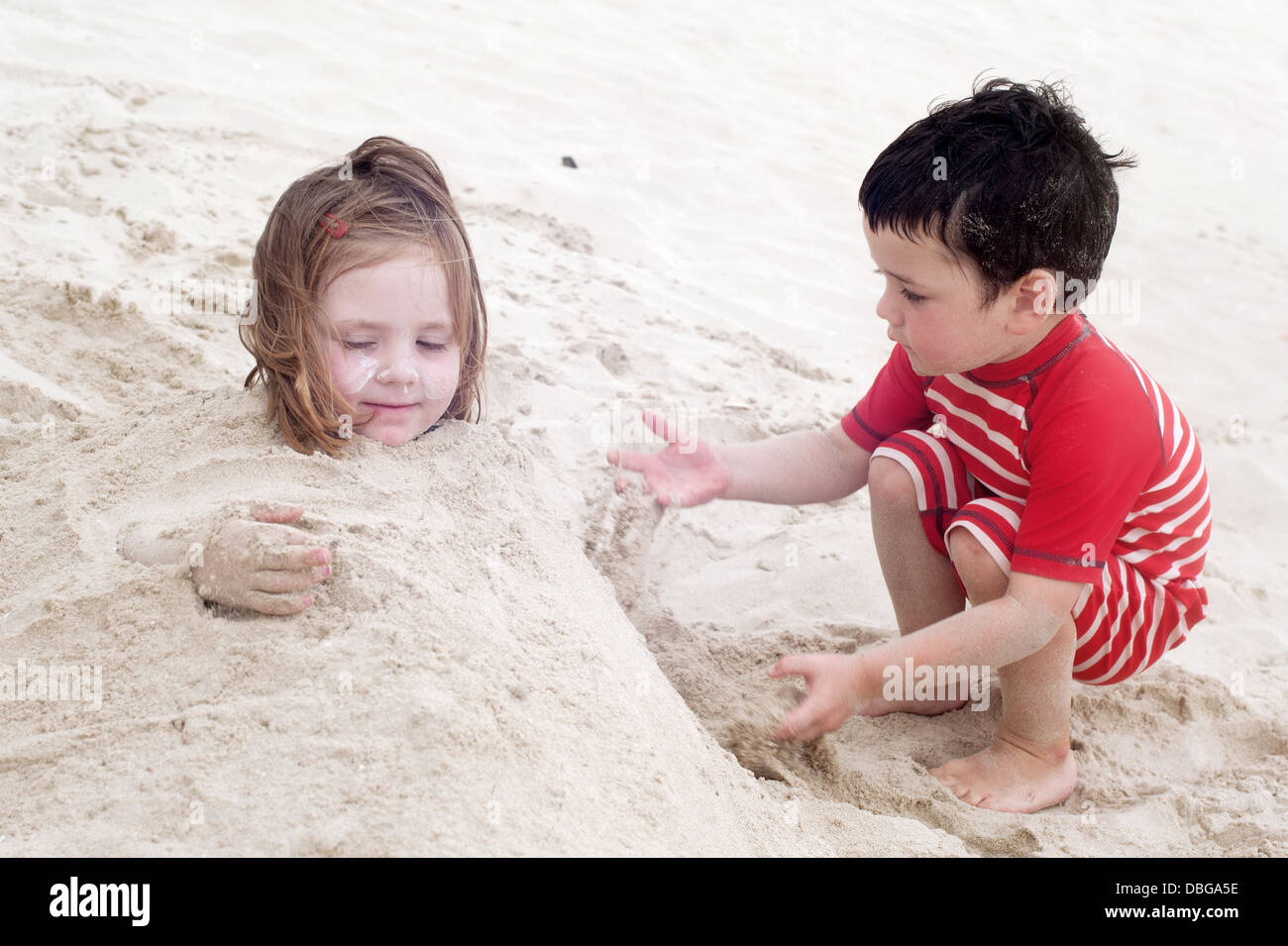 Boy and girl playing with sand hi-res stock photography and images - Alamy