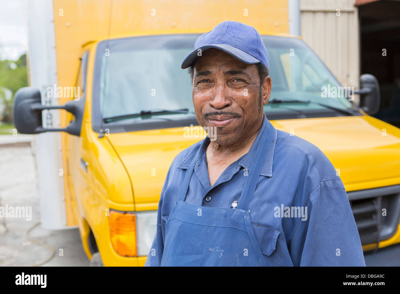 African American worker smiling by truck Stock Photo - Alamy