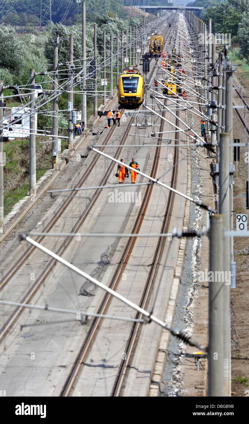 Railway workers repair the ICE highspeed railway line that was flooded ...