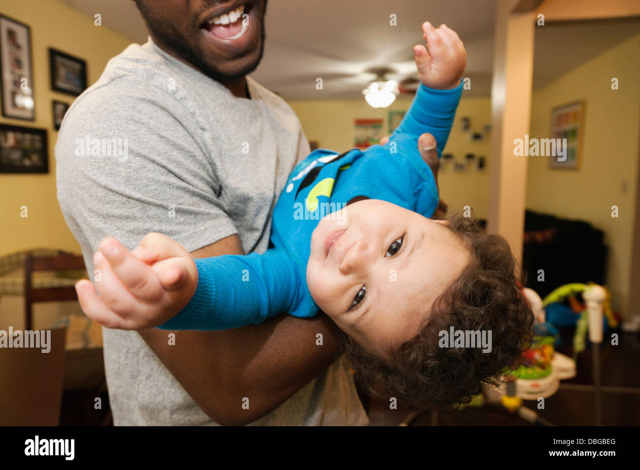 Father playing with baby in living room Stock Photo - Alamy