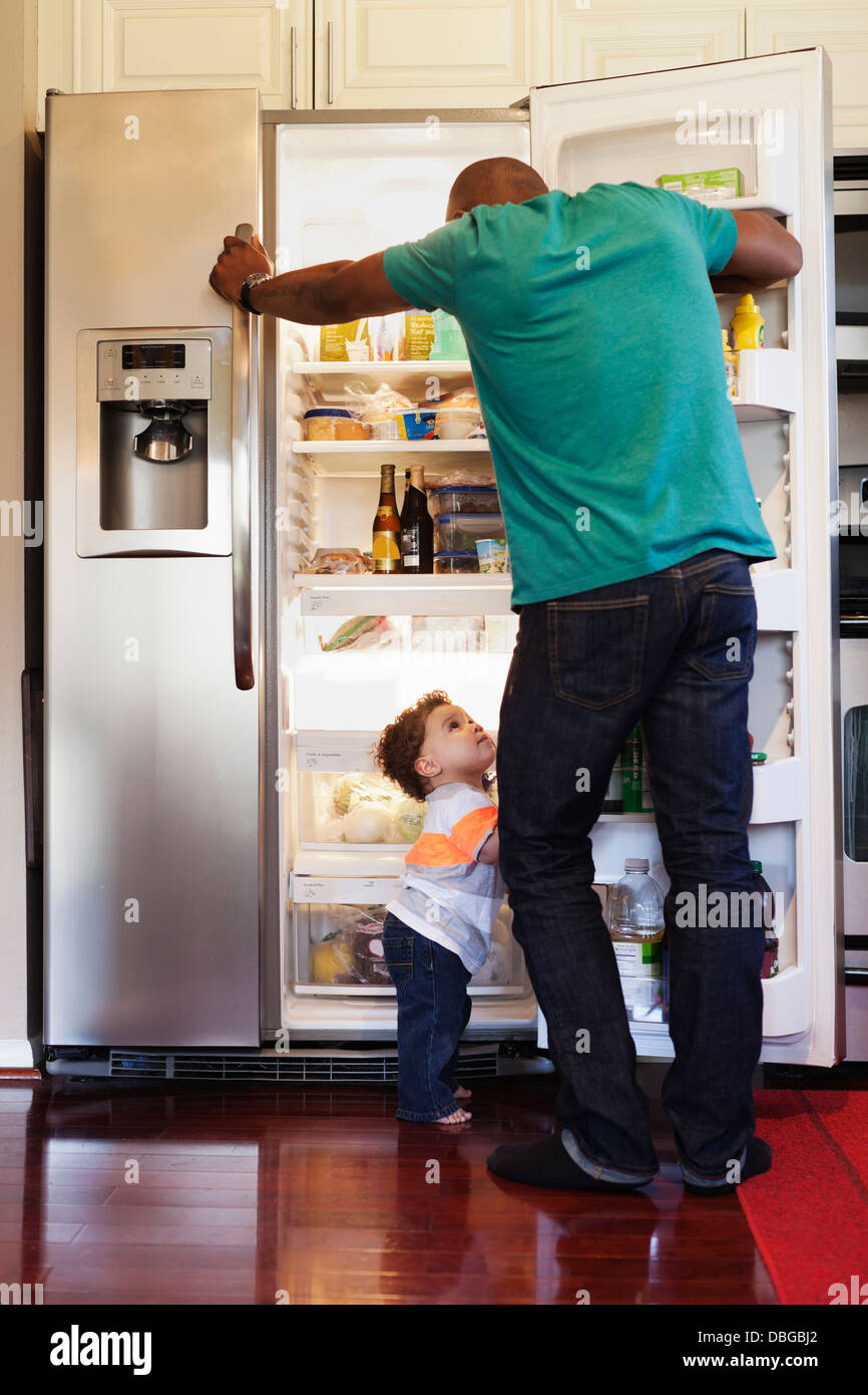 Father and baby looking through fridge Stock Photo - Alamy