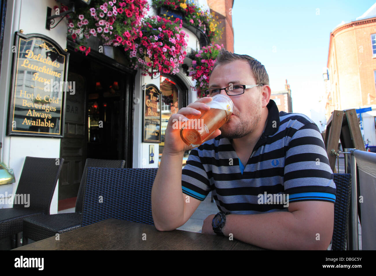Man drinking a pint of beer outside a pub alone Stock Photo - Alamy