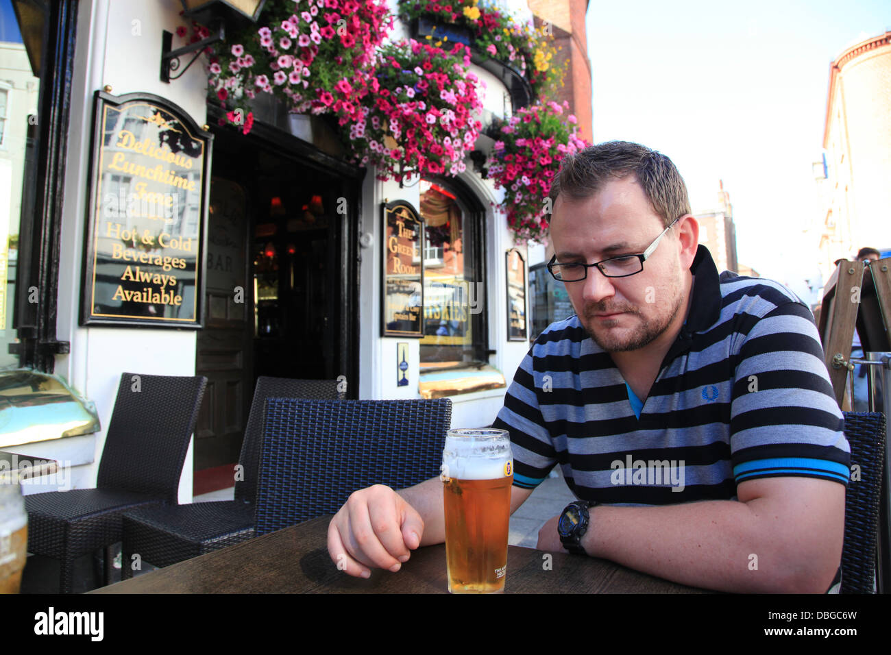 Man drinking a pint of beer outside a pub alone Stock Photo - Alamy