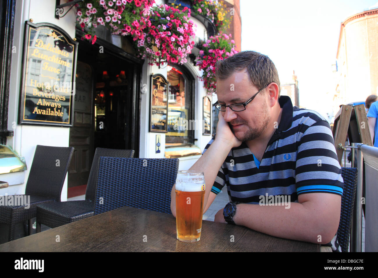 Man drinking a pint of beer outside a pub alone Stock Photo - Alamy