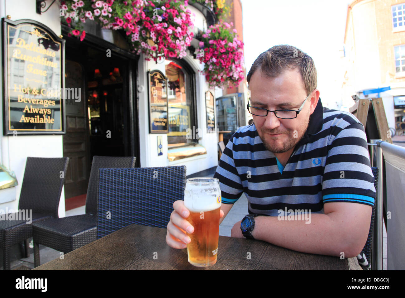 Man drinking a pint of beer outside a pub alone Stock Photo - Alamy