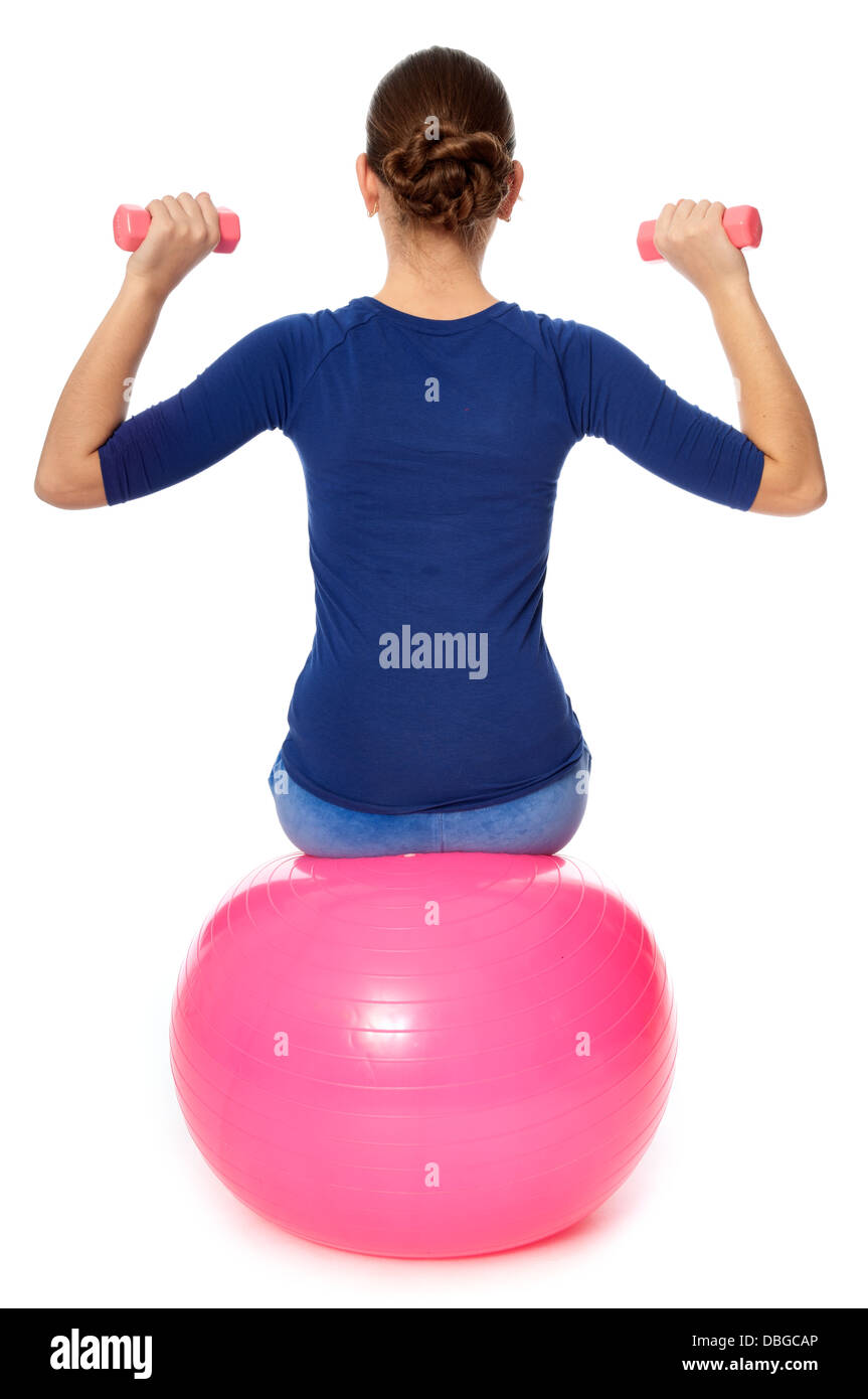 Exercises with dumbbells on a gymnastic ball Stock Photo - Alamy