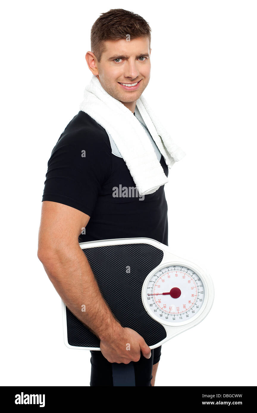 Healthy young man with a weight scale Stock Photo - Alamy