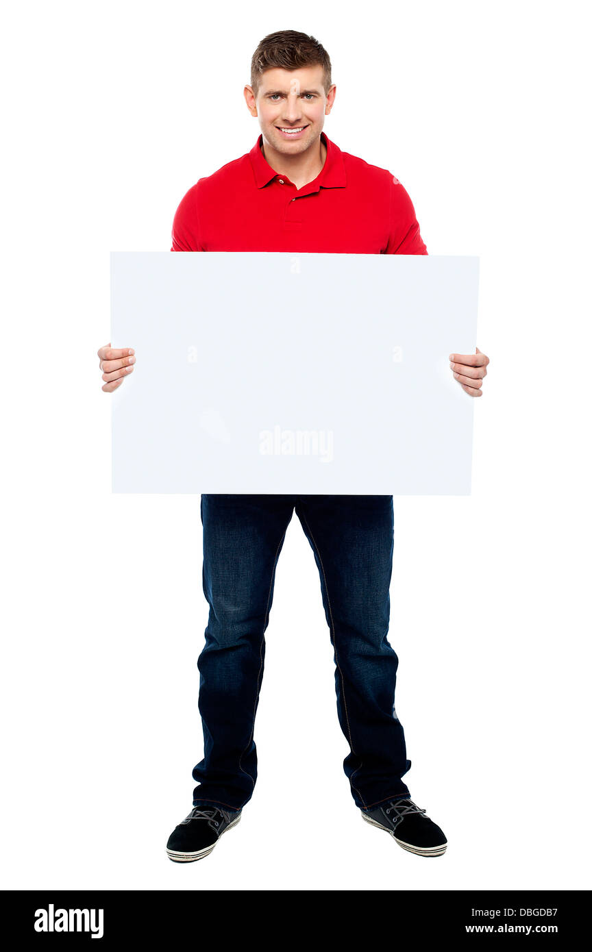 Handsome guy presenting blank billboard to camera Stock Photo - Alamy