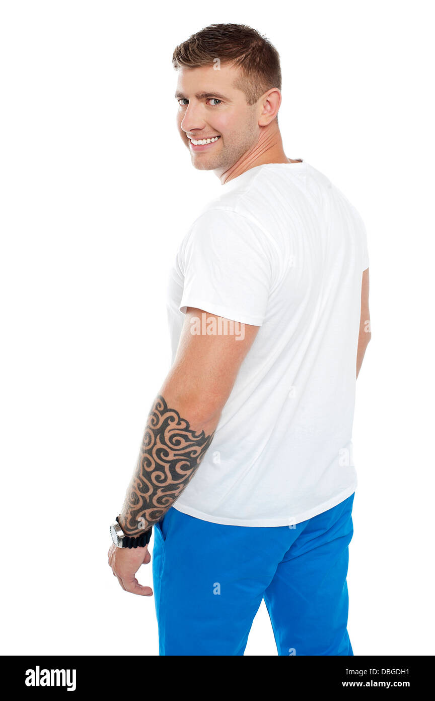 Young smiling man with tattoo on hand turning back Stock Photo - Alamy