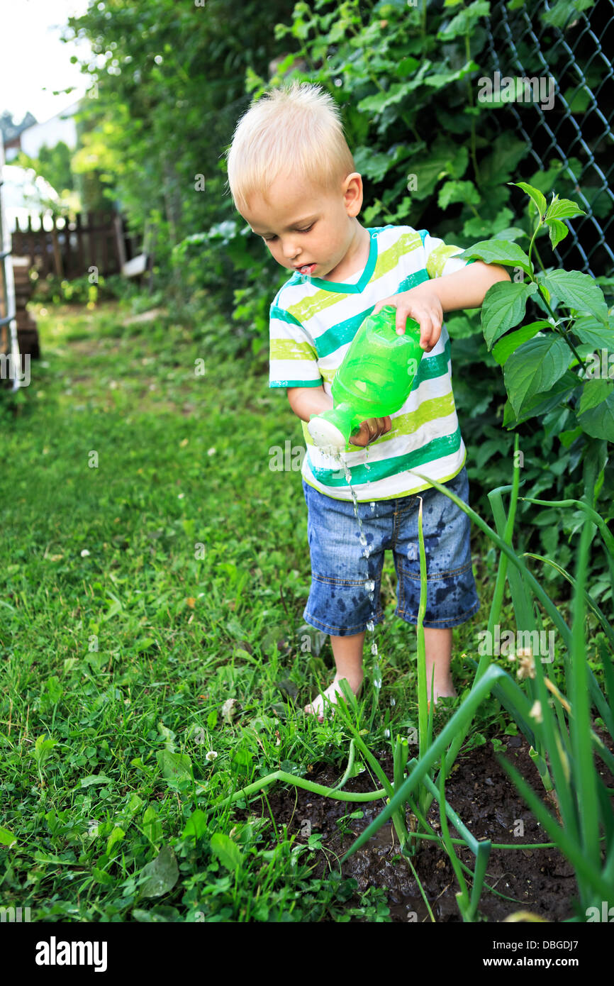 little boy playing with toy tools in the backyard Stock Photo - Alamy