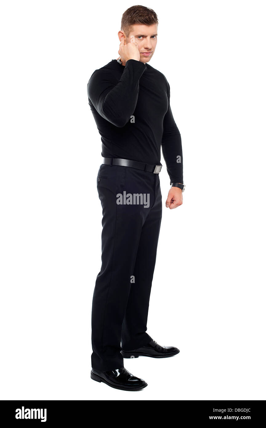 Strong bouncer listening carefully. Full length shot Stock Photo - Alamy