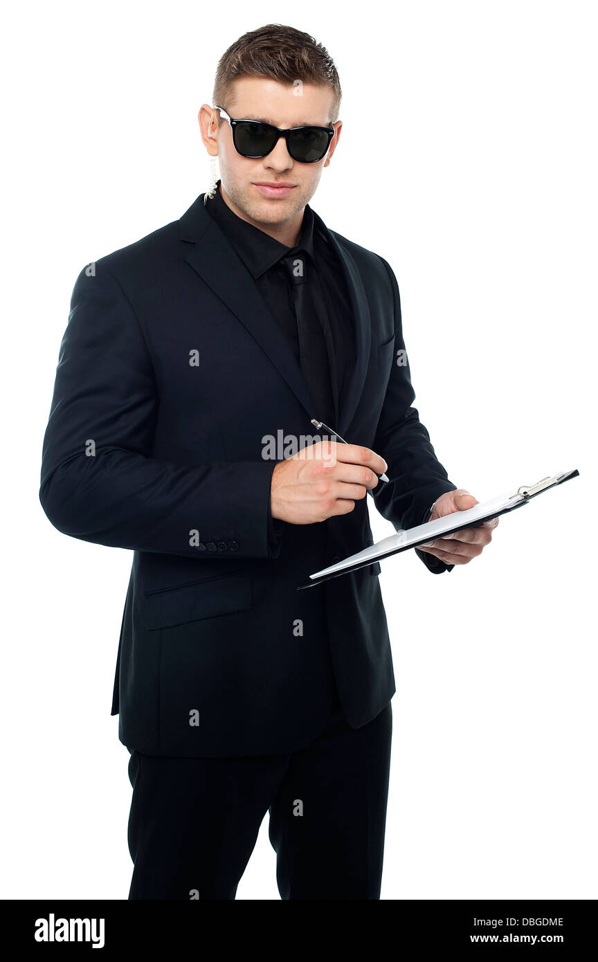 Security officer writing on clipboard Stock Photo - Alamy