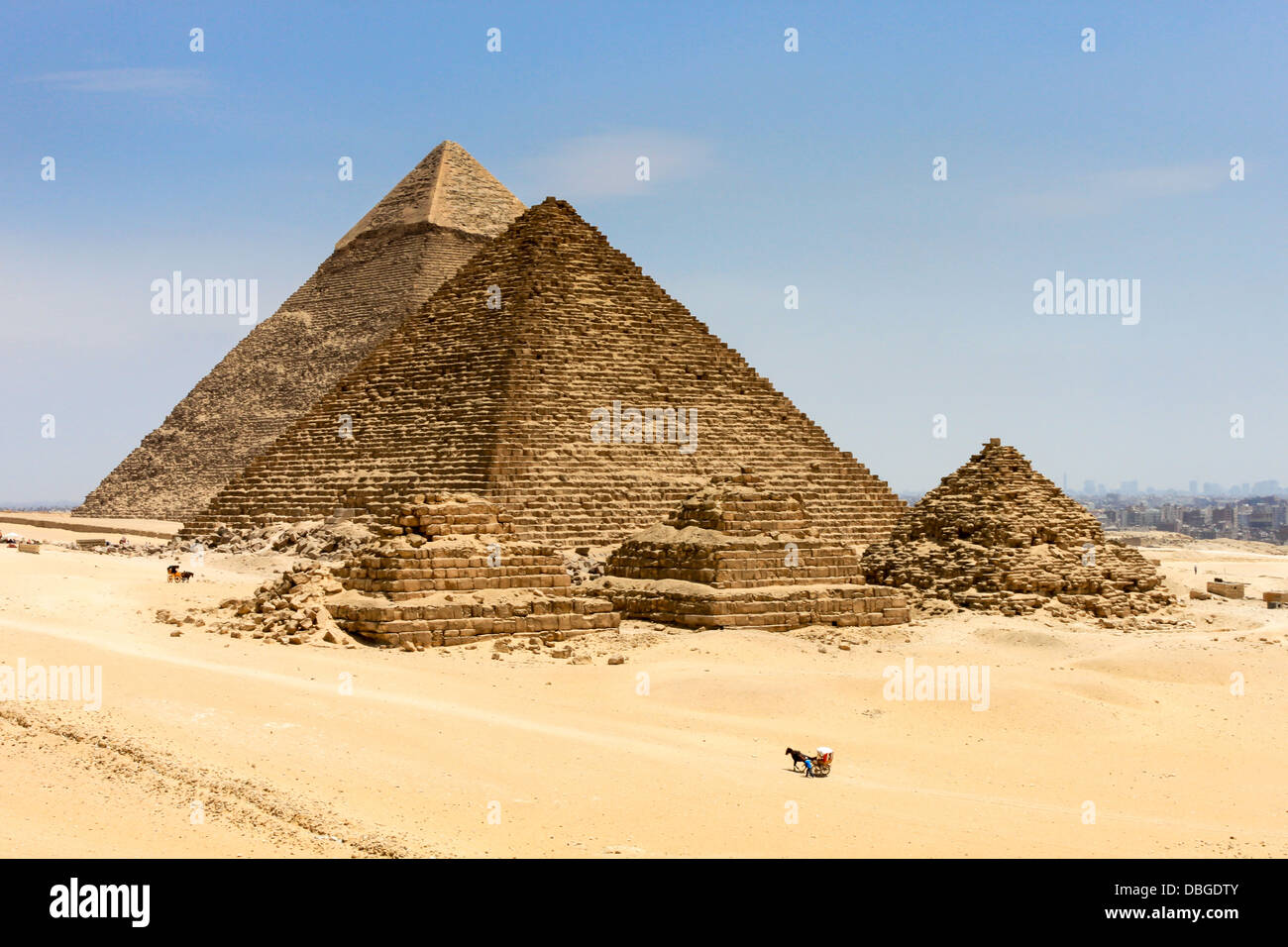 A photograph of the pyramids of Giza with the city of Cairo in the ...