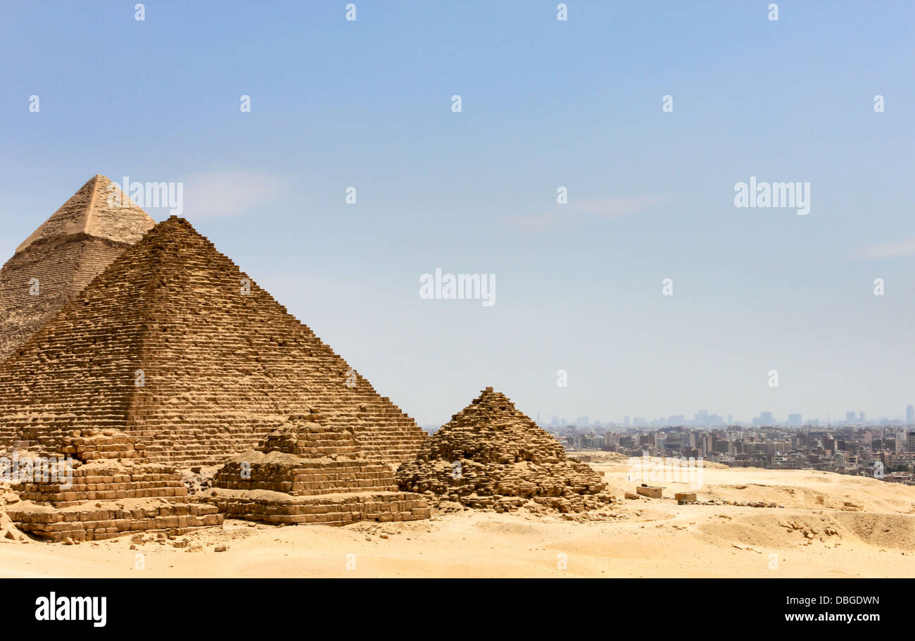 A photograph of the pyramids of Giza with the city of Cairo in the ...