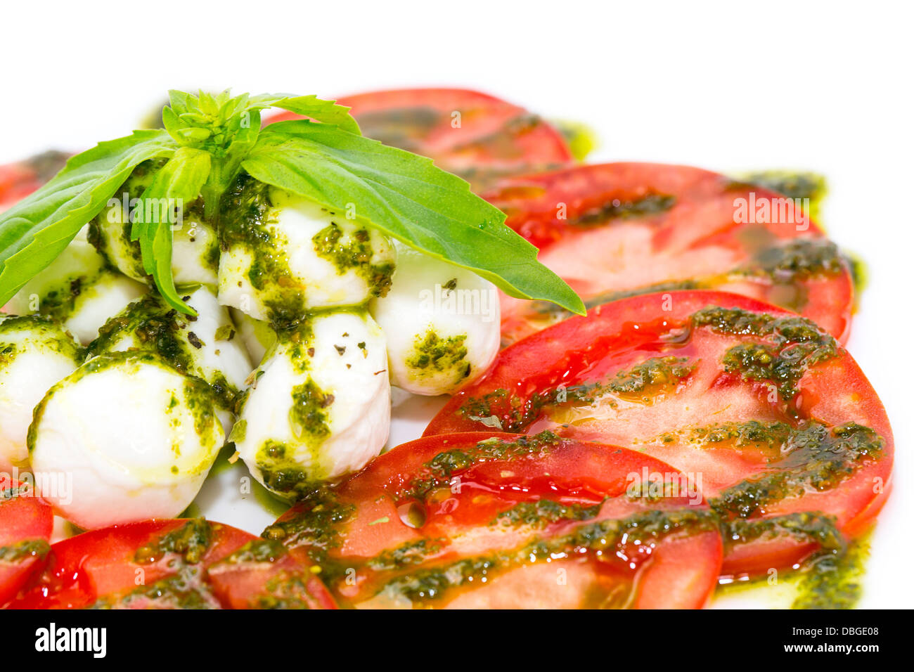 tomatoes with cheese sauce poured on a white plate in a restaurant ...