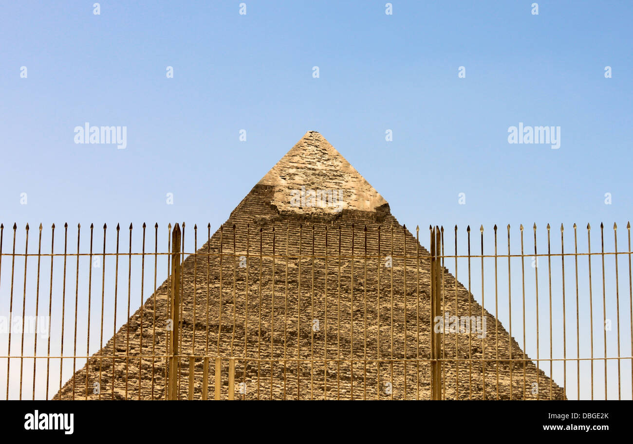 A photograph of an Egyptian Pyramid behind a fence. It depicts the ...
