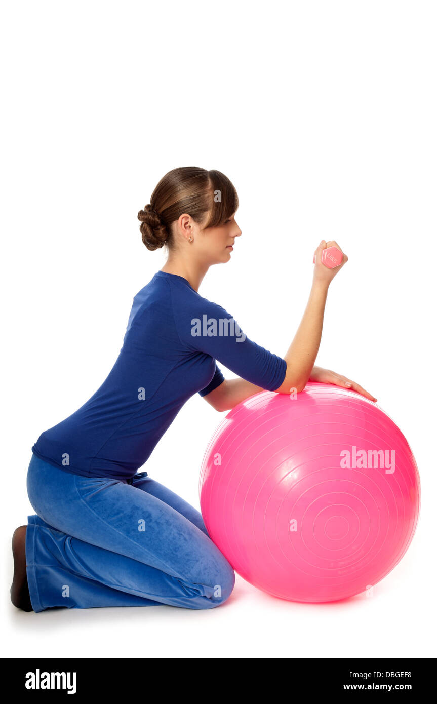 Exercises with dumbbells on a gymnastic ball Stock Photo - Alamy