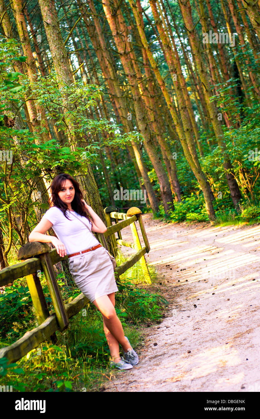 An image o girl walking through the forest pathway Stock Photo - Alamy