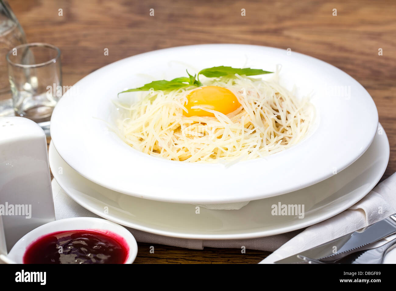 spaghetti with egg on a table in a restaurant Stock Photo - Alamy