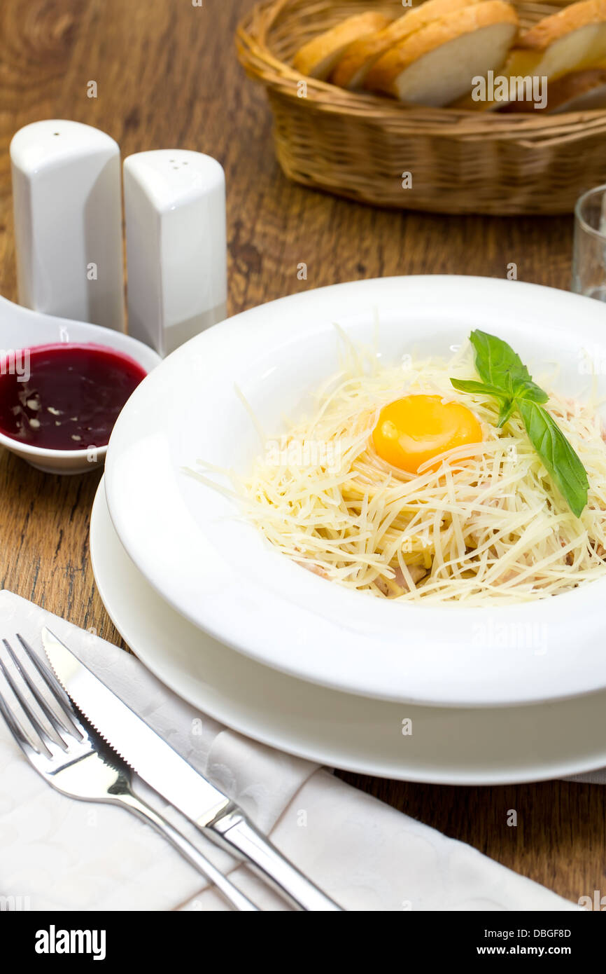 spaghetti with egg on a table in a restaurant Stock Photo - Alamy