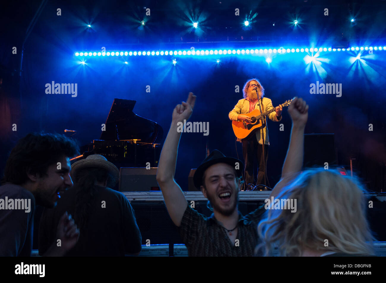 Spectators sing along with Canadian singer Ben Caplan singing and ...