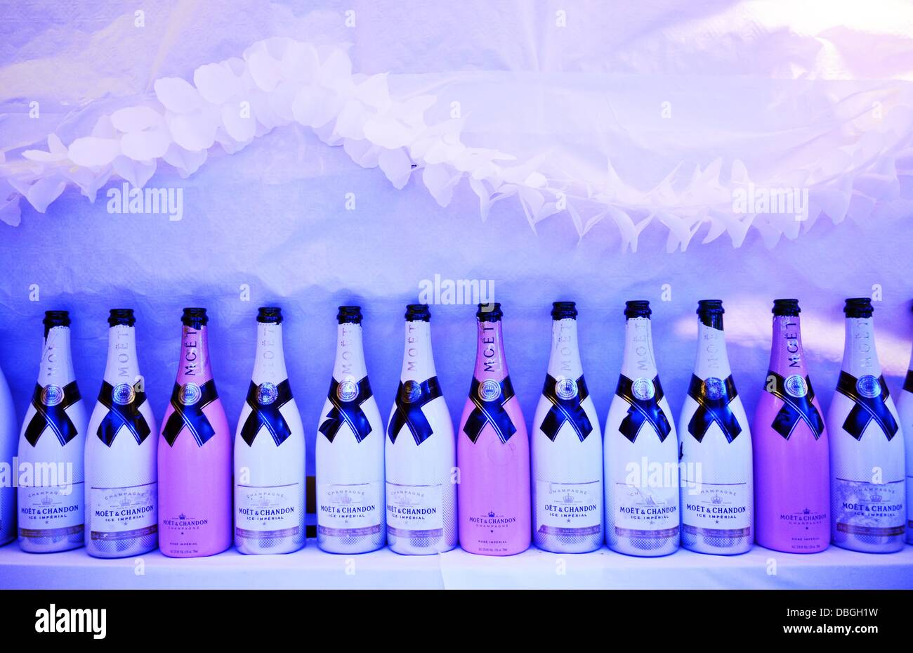 White and pink colored champaign bottles during the Fete Blanche at the ...