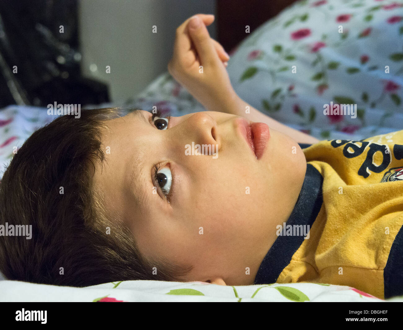 A young boy undergoes rigorous stretching exercises in physiotherapy ...