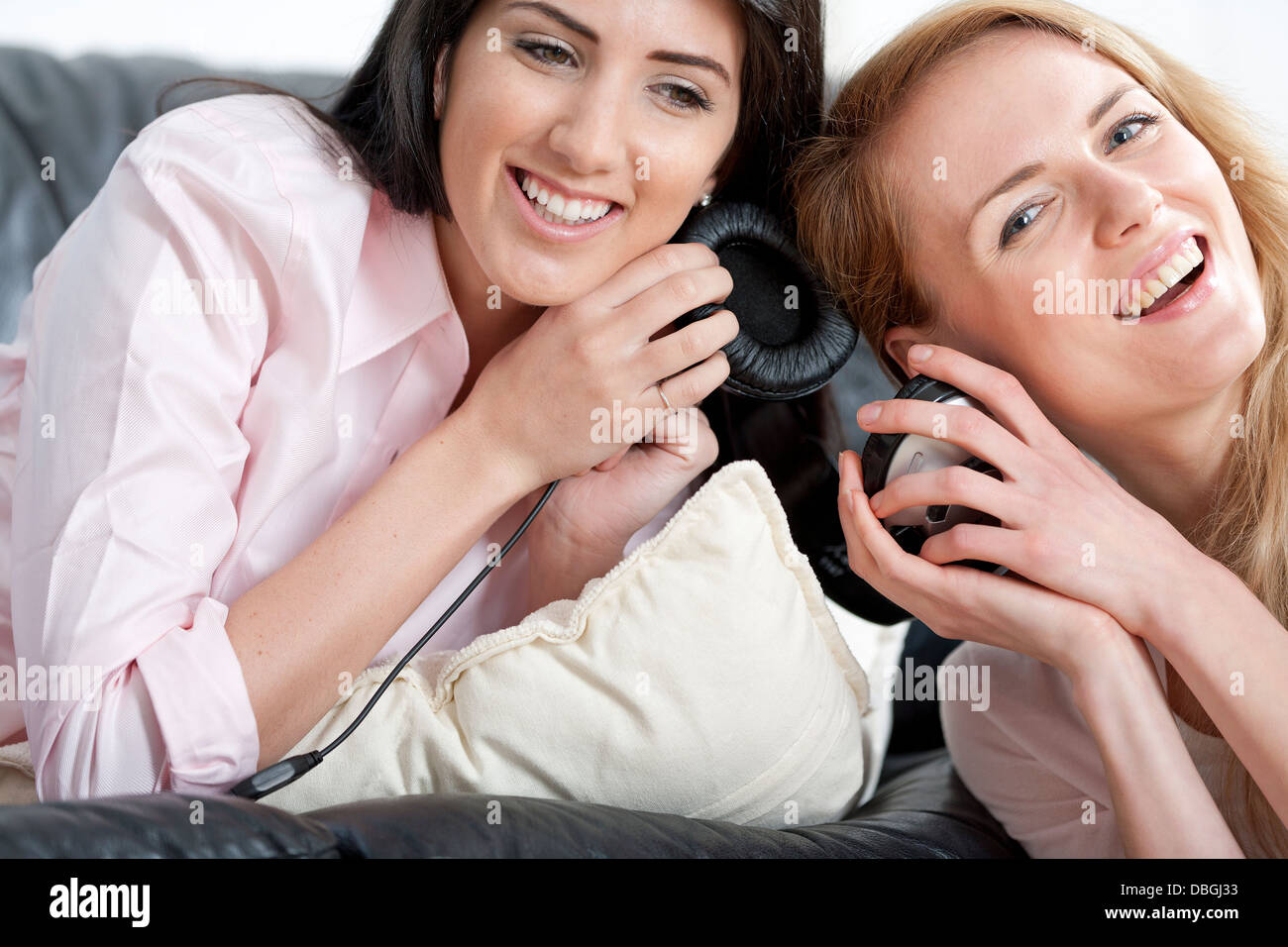 Two friends listening to music Stock Photo - Alamy