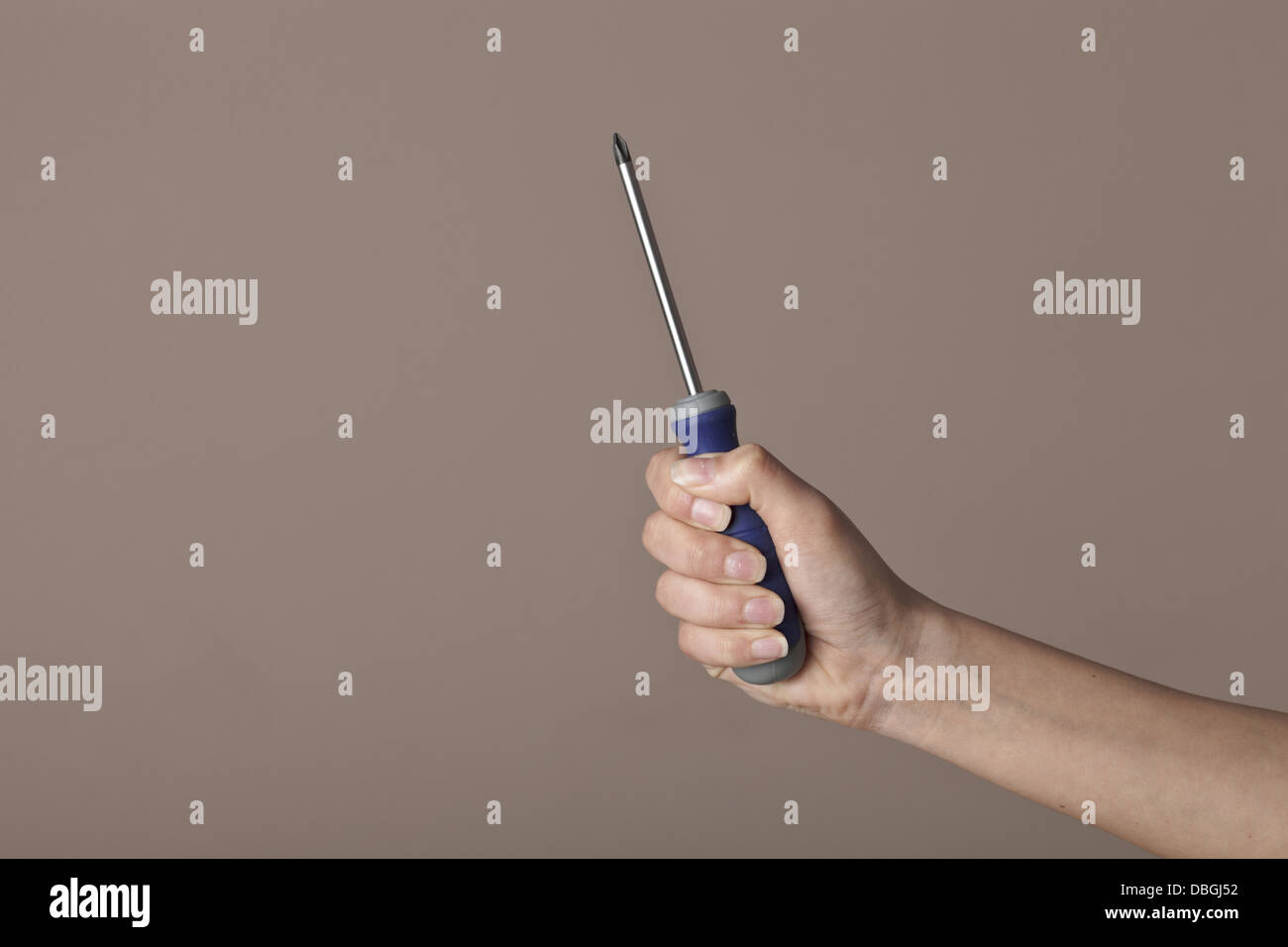 Hand holding screwdriver Stock Photo - Alamy