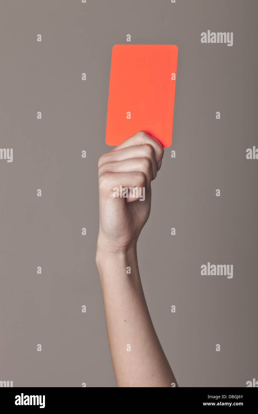Woman's hand holding red card Stock Photo - Alamy