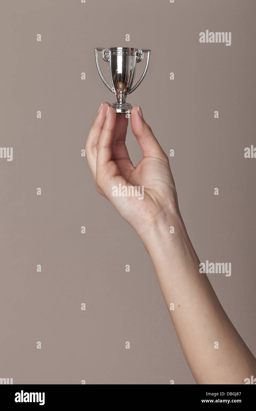 Hand holding trophy hi-res stock photography and images - Alamy