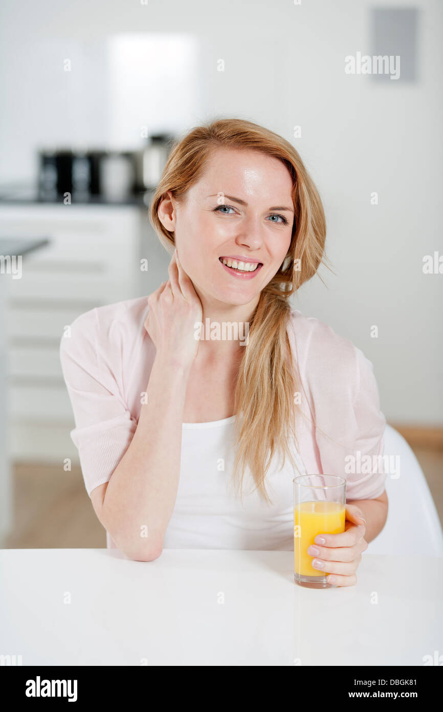 Young woman sat at table Stock Photo - Alamy