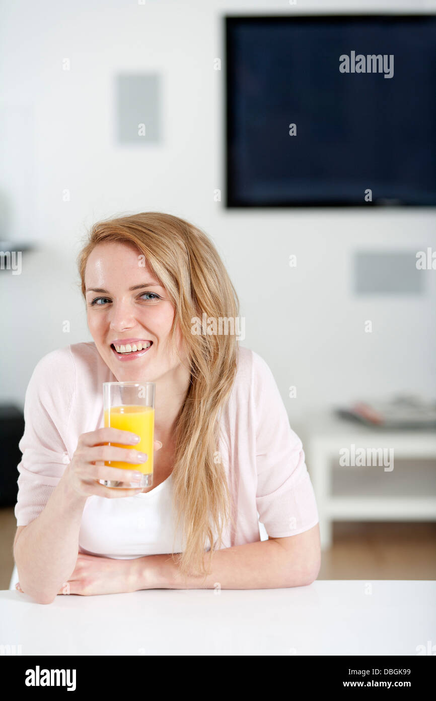 Young woman sat at table Stock Photo - Alamy