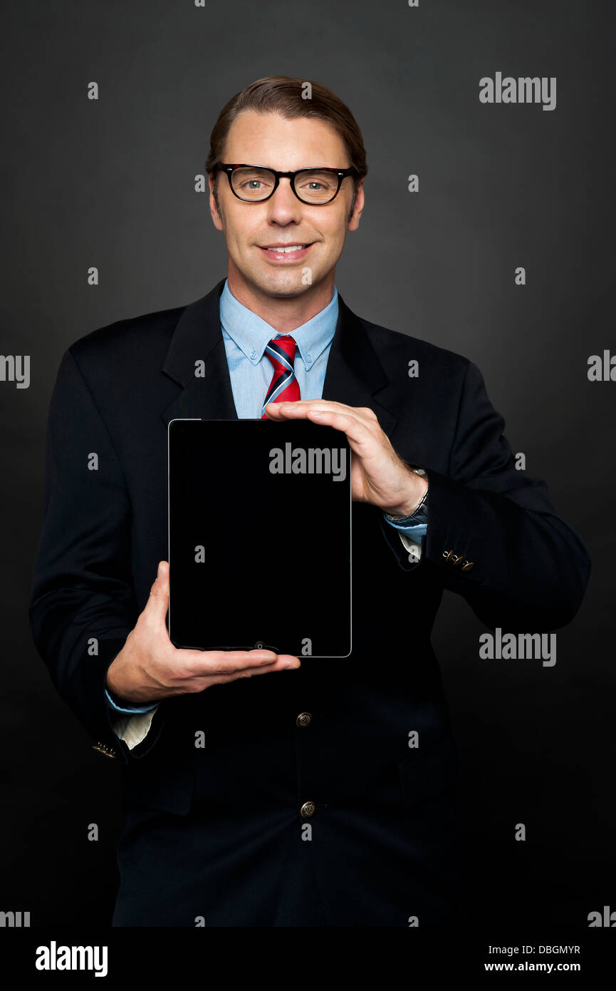 Portrait of businessman showing new digital device Stock Photo - Alamy
