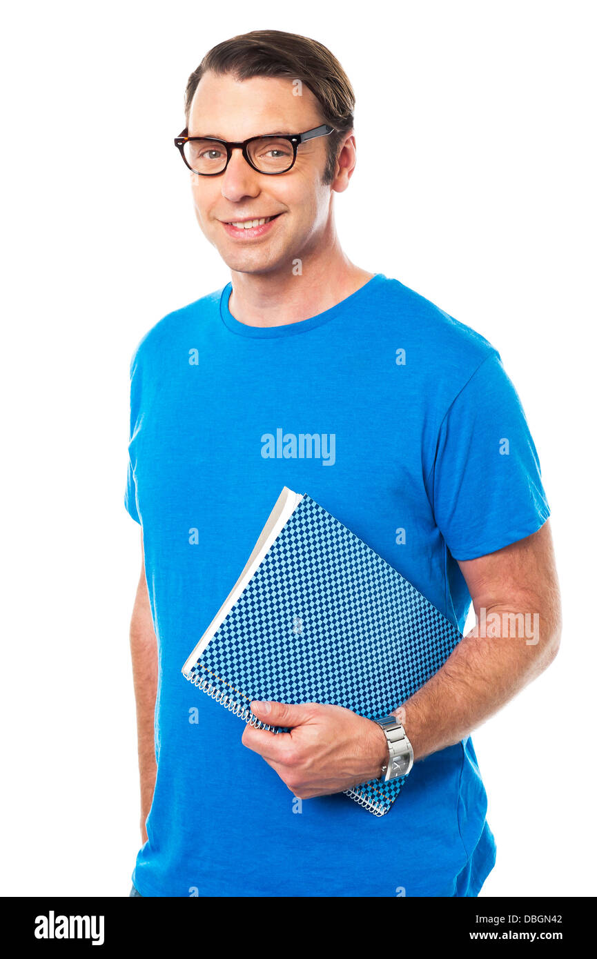 Casual young guy holding notepad Stock Photo - Alamy