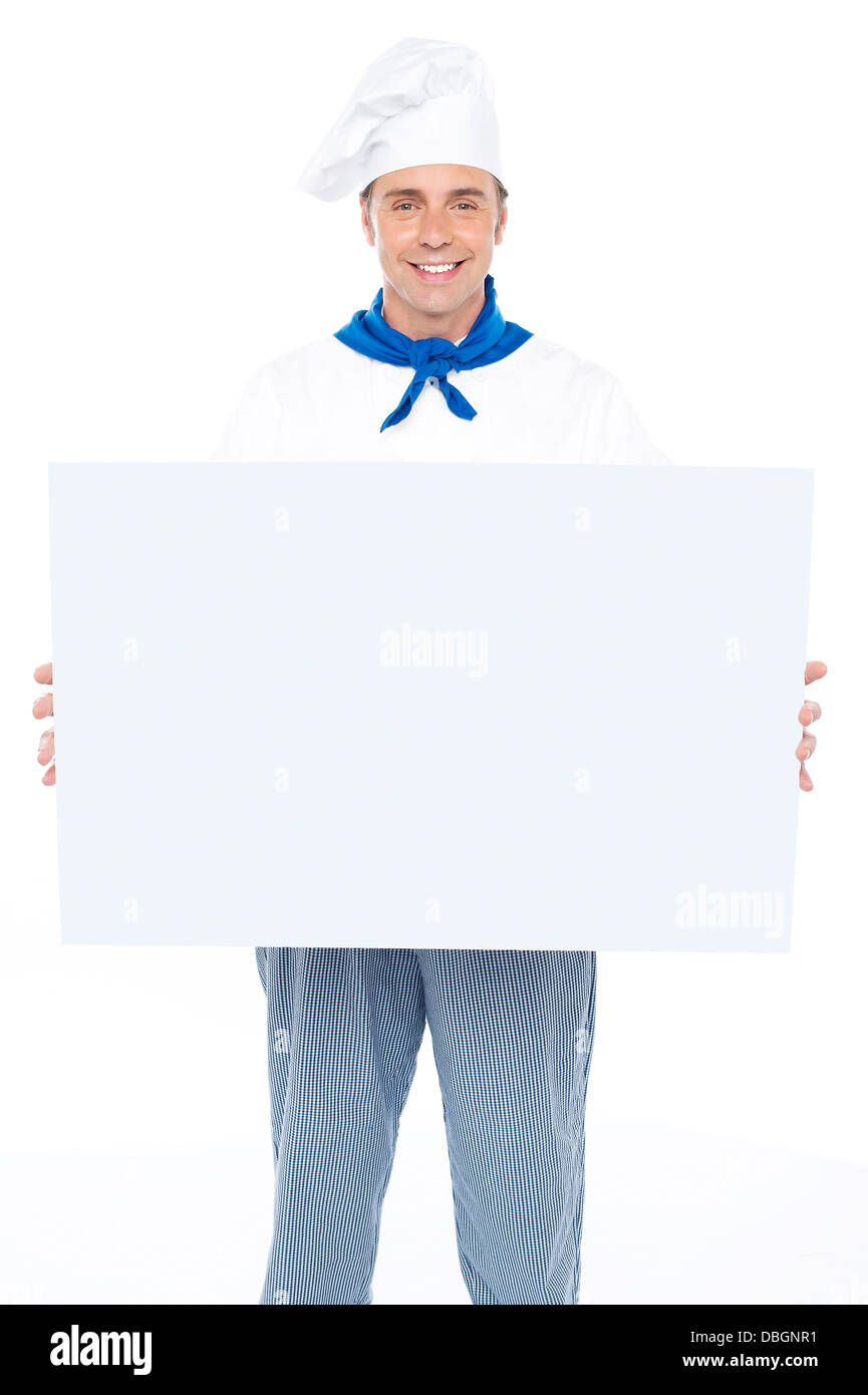 Handsome male chef holding ad board Stock Photo - Alamy
