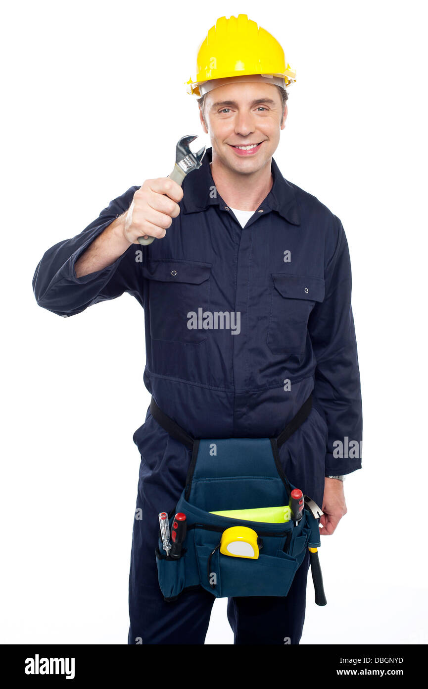 Smiling repairman holding out screwdriver Stock Photo - Alamy