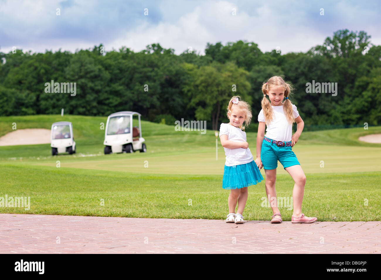 Cute little sportive gilrs on the golf course Stock Photo - Alamy