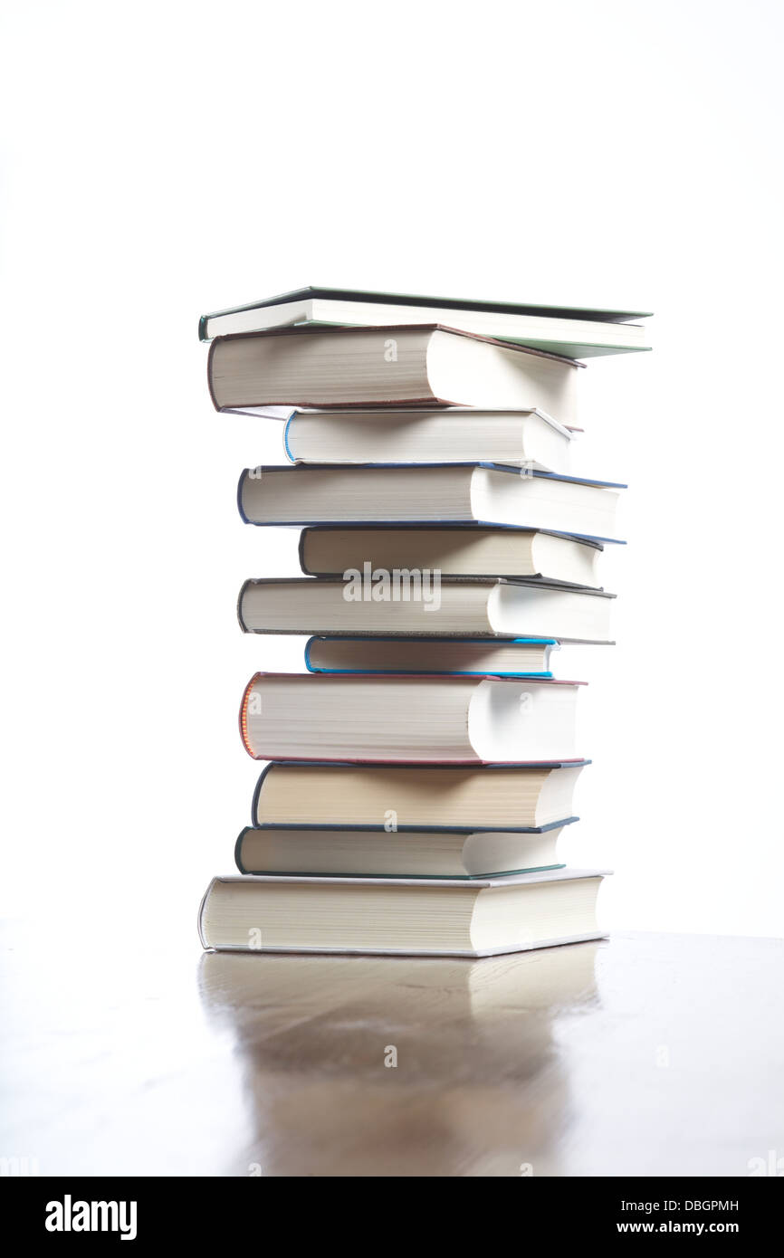 books piled on table Stock Photo - Alamy