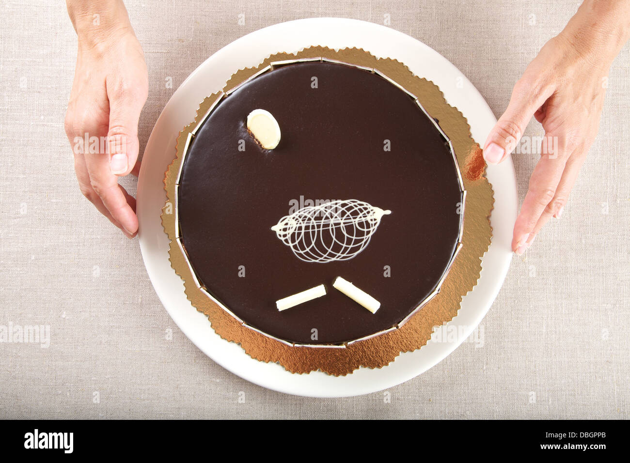 hands placing a chocolate cake Stock Photo - Alamy