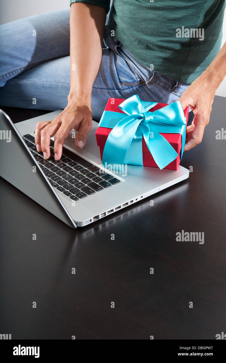 typing in laptop with gift box Stock Photo - Alamy